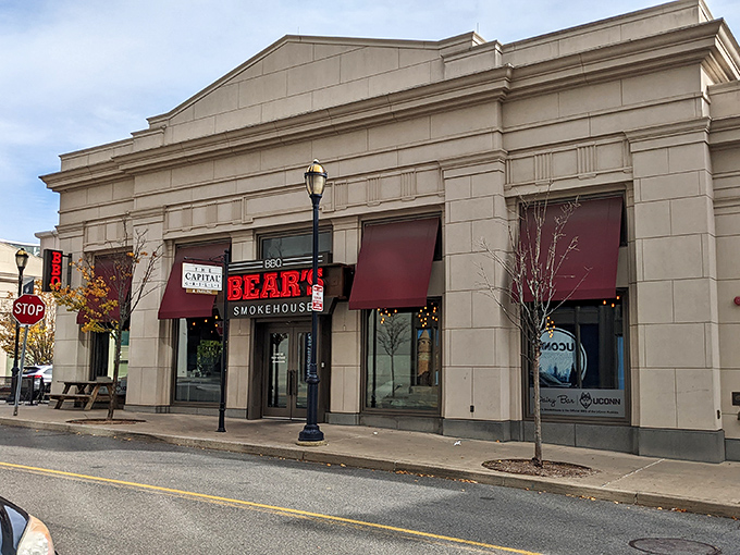 The stone facade of Bear's Smokehouse stands like a temple to barbecue, its bold red sign a beacon to hungry pilgrims seeking smoky salvation.