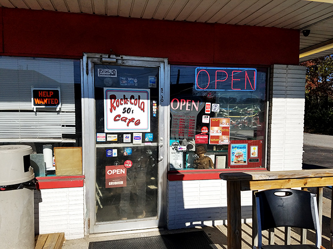 The unassuming entrance to Rock-Cola 50's Cafe might not scream "culinary destination," but that neon OPEN sign is your portal to breakfast nirvana.