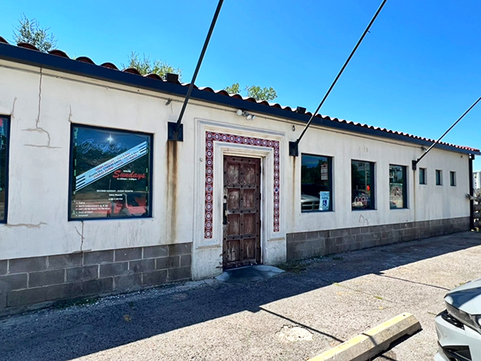 Three flags flutter proudly outside this unassuming barbecue sanctuary, where the red tile roof and stucco walls hide smoky treasures within.