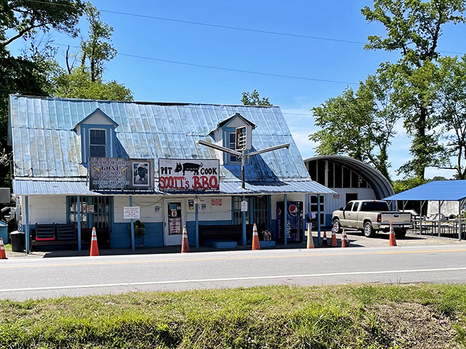 The pilgrimage destination itself: Scott's Bar-B-Que stands proudly with its metal roof and blue-trimmed exterior, a humble temple to smoked meat perfection.