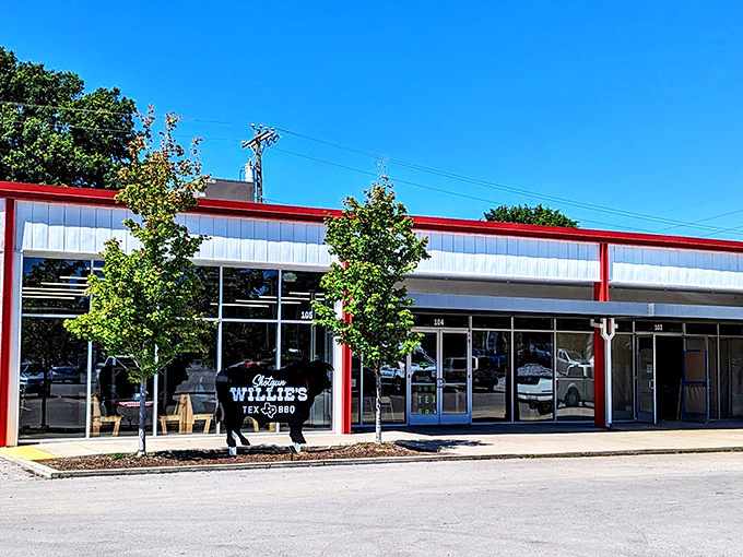 The iconic black cow sign stands guard outside this unassuming strip mall location, promising Texas-sized flavor inside.