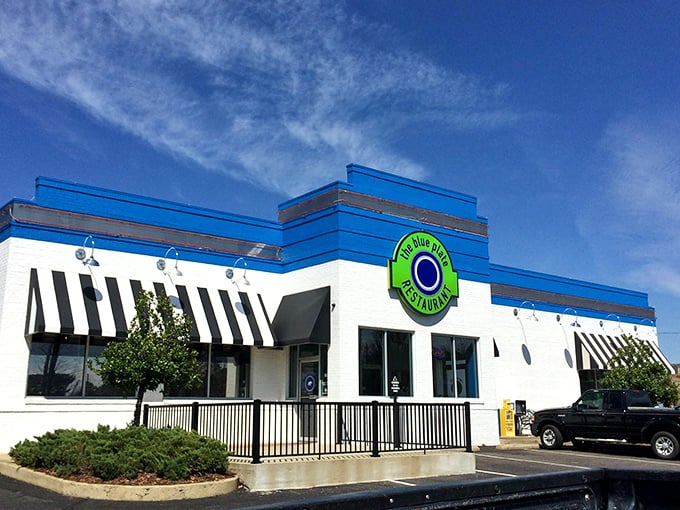 The Blue Plate's vibrant exterior stands out like a beacon of culinary hope. That bright blue and white building promises Southern comfort before you even step inside. 