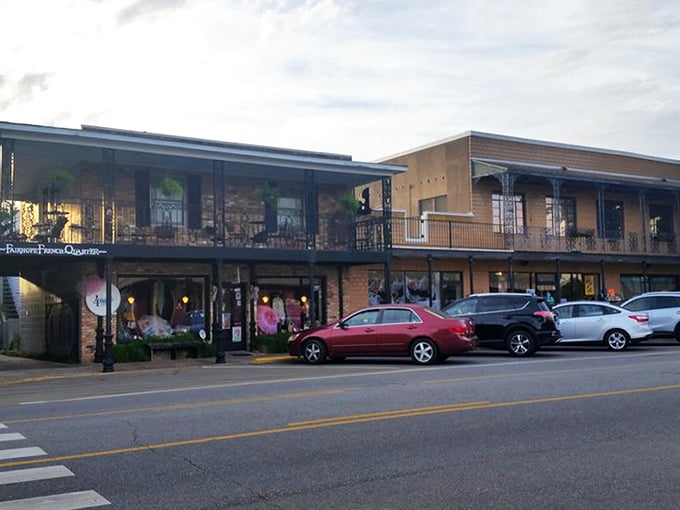 The iconic brick exterior of Page & Palette stands like a literary lighthouse on Fairhope's corner, beckoning bookworms with its New Orleans-inspired balconies.