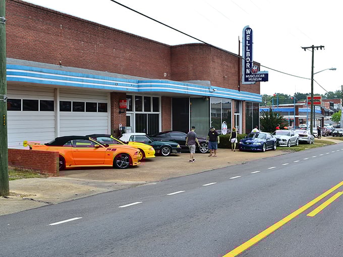 That vintage neon sign beckoning from the street promises automotive adventures that'll make your heart race faster than a Hemi.