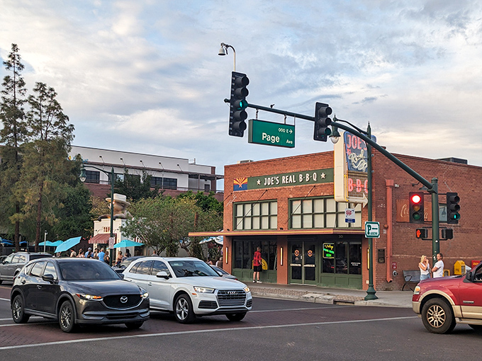 The brick fortress of flavor stands proudly on Gilbert's corner, its Arizona flag-adorned sign promising smoky treasures within. A barbecue beacon in the desert.