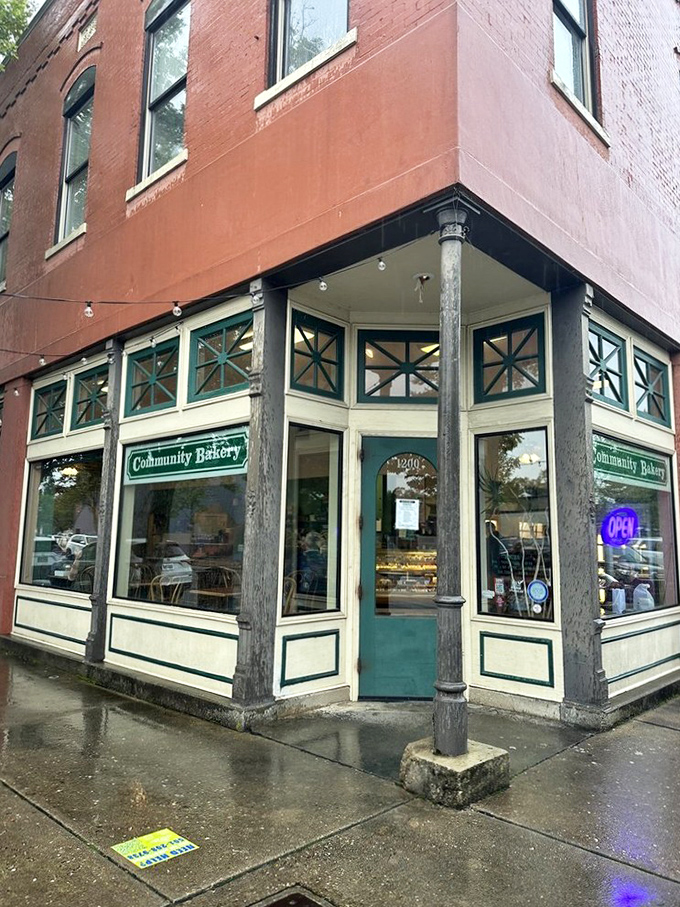 The iconic teal-trimmed entrance of Community Bakery beckons like an old friend, promising carb-laden treasures behind that glowing "OPEN" sign.