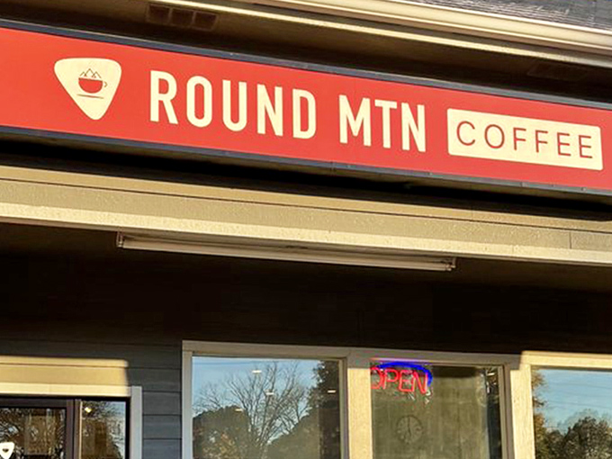 That distinctive orange sign beckons like a lighthouse for the caffeine-deprived, promising salvation in a cup just beyond those welcoming doors.