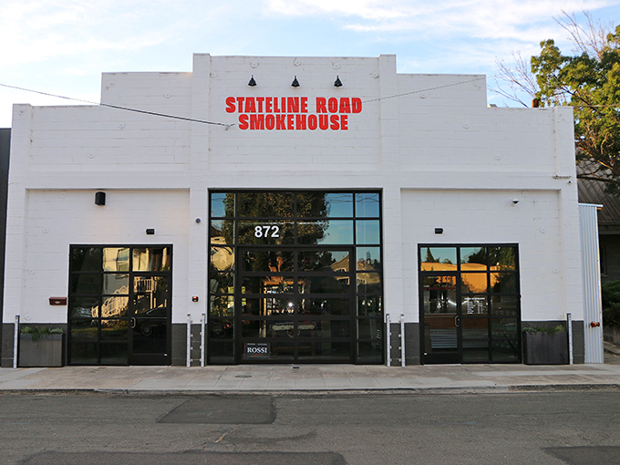 The unassuming white exterior of Stateline Road Smokehouse stands like a blank canvas, ready to paint your taste buds with smoky masterpieces.