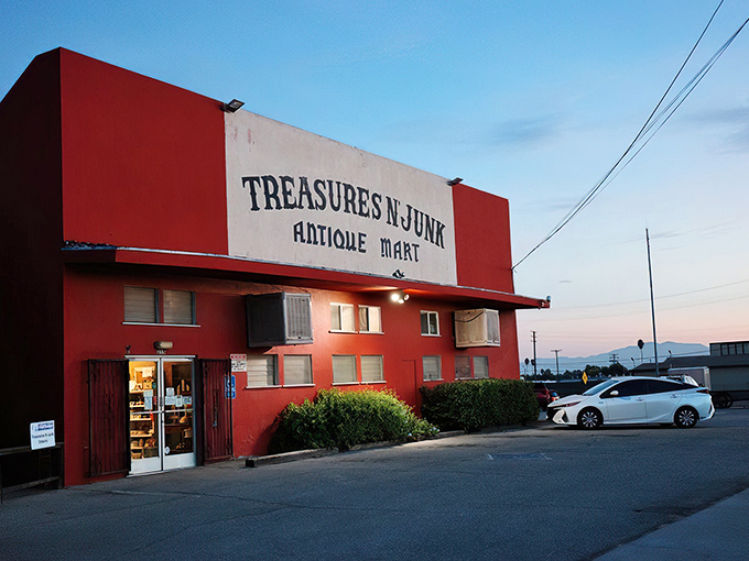 The terracotta fortress of forgotten treasures stands proudly on an Ontario street corner, its weathered sign promising both the sublime and the ridiculous.