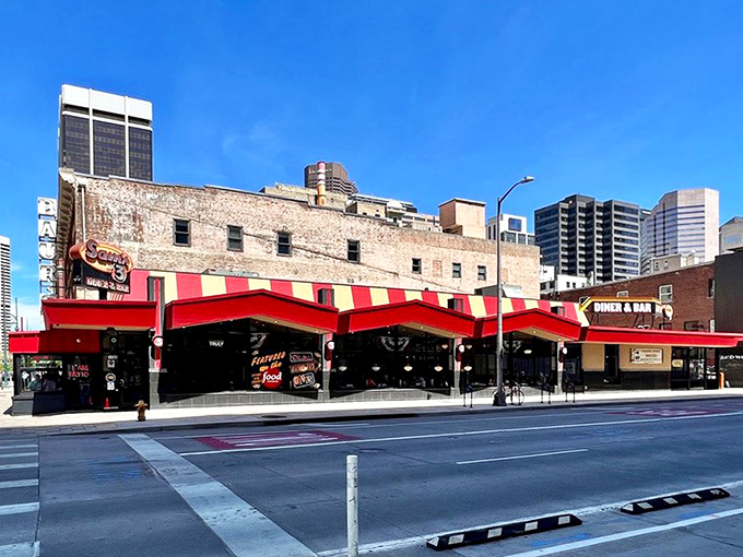 Sam's No. 3 stands proudly with its iconic red awning, a beacon of comfort food amid downtown Denver's glass skyscrapers. Classic diner meets modern city.