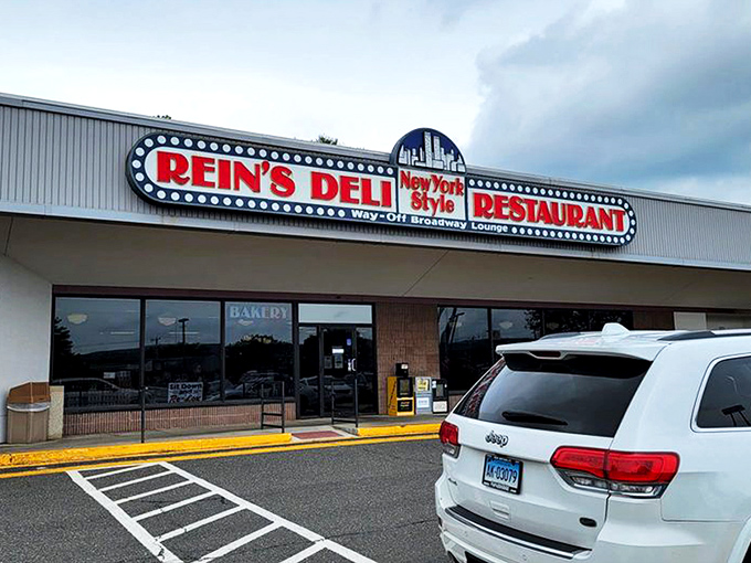 The iconic yellow exterior of Rein's Deli stands like a beacon of hope for hungry travelers on I-84, promising New York deli salvation in Connecticut.