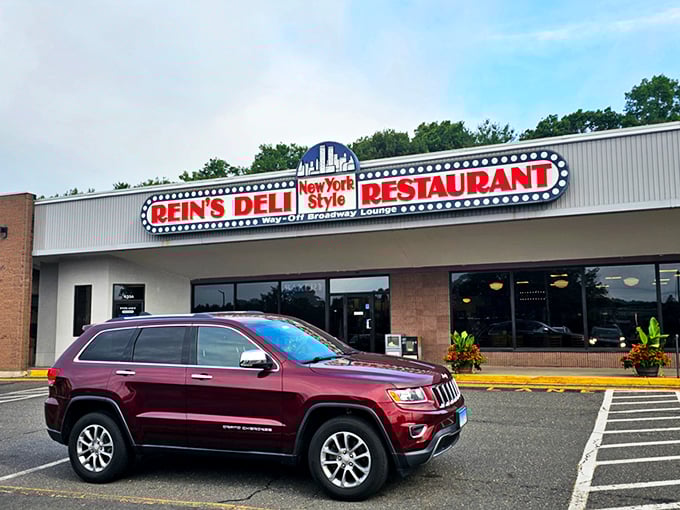 The iconic Rein's Deli sign glows like a Broadway marquee in Connecticut, promising New York flavors without the traffic or attitude.