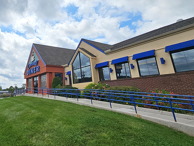 The Cromwell Diner's distinctive blue and orange exterior welcomes hungry travelers like a lighthouse beacon for breakfast enthusiasts navigating the sea of morning hunger.