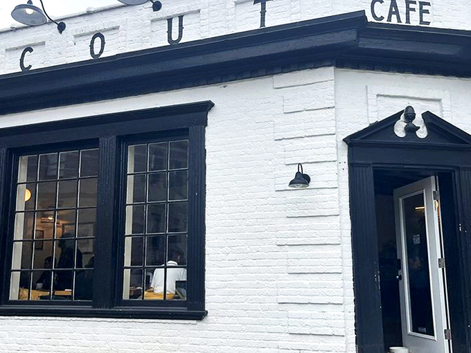 Scout Cafe's charming white brick exterior stands like a coffee oasis in Wilmington's Forty Acres neighborhood, promising caffeinated treasures within.