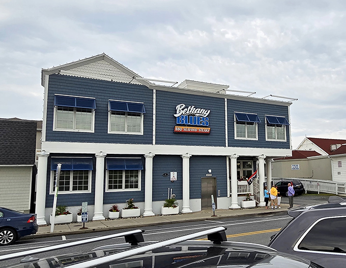 The coastal charm of Bethany Blues' exterior promises what lies within&mdash;a temple of smoke where beach vibes meet barbecue brilliance.