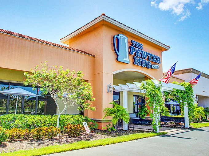 The Pewter Mug North stands proud against the Florida sky, American flags waving a patriotic welcome to hungry visitors.