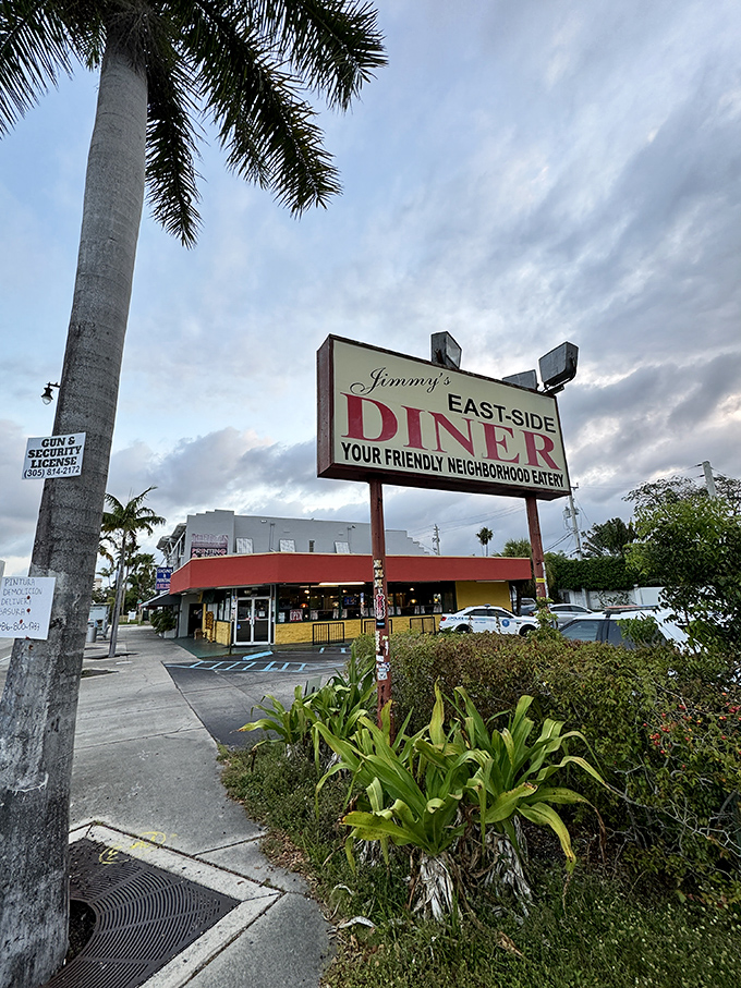 The iconic red and yellow exterior of Jimmy's Eastside Diner stands as a beacon of breakfast hope amid Miami's palm trees and sunshine.