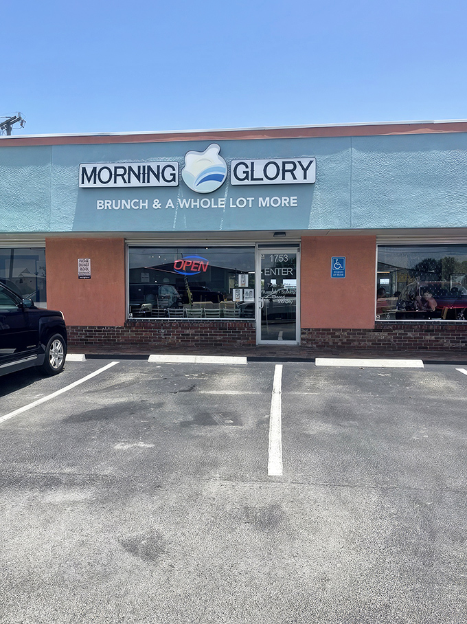 Morning Glory's cheerful blue exterior promises breakfast salvation for hungry beachgoers. The "Brunch & A Whole Lot More" tagline isn't just marketing&mdash;it's a delicious prophecy.