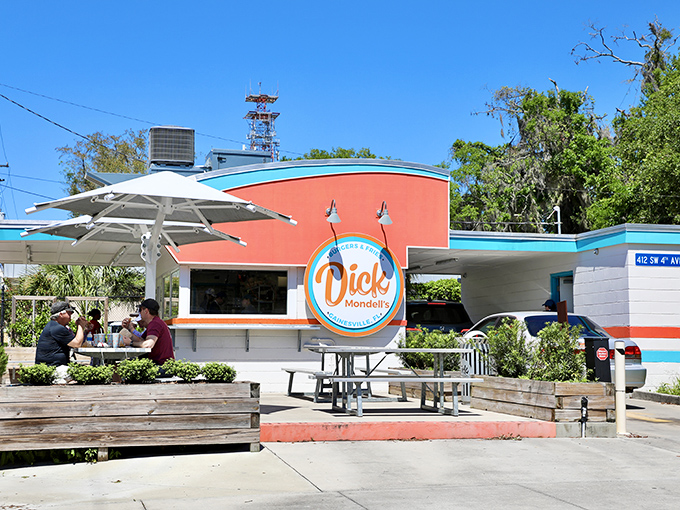 The bright orange and turquoise exterior isn't just eye-catching&mdash;it's a siren call to burger lovers everywhere. Florida sunshine and shade umbrellas complete the perfect dining setup.