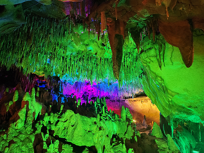 The cave's vibrant lighting transforms ancient limestone into nature's own psychedelic light show. Mother Nature's been decorating for millions of years, and it shows.