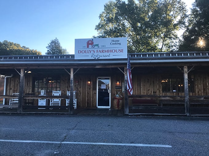 The rustic wooden exterior of Dolly's Farmhouse Restaurant promises authenticity before you even step inside. That American flag isn't just decoration&mdash;it's a guarantee.