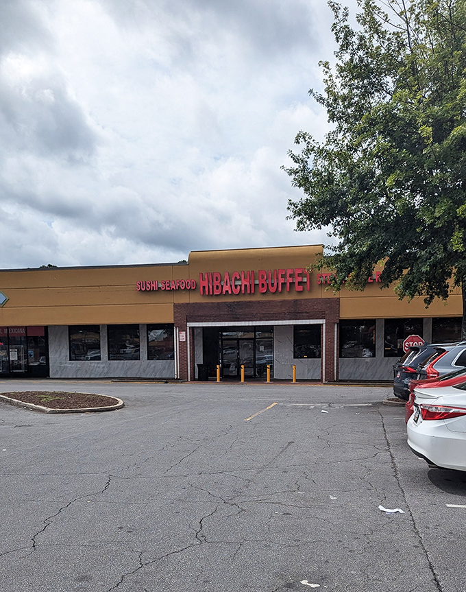 The golden-yellow exterior of Hibachi Buffet beckons like a beacon of culinary abundance on Buford Highway, with its bold red lettering promising seafood, steak, and prime rib adventures within.