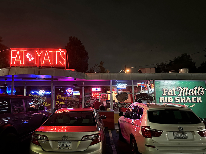 That neon glow isn't just lighting up the night—it's a beacon calling hungry souls to barbecue salvation on Piedmont Avenue.