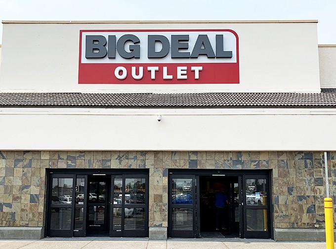 The unassuming exterior of Big Deal Outlet stands like a temple to thriftiness under Idaho's endless blue sky. Retail paradise awaits inside.