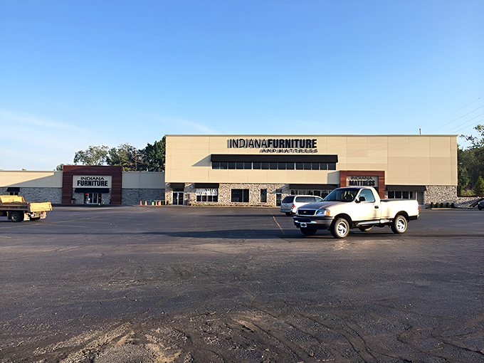The modern exterior blends warm wood paneling with stone accents, creating a fa&ccedil;ade that says "Yes, I'm a furniture store, but I've got style."
