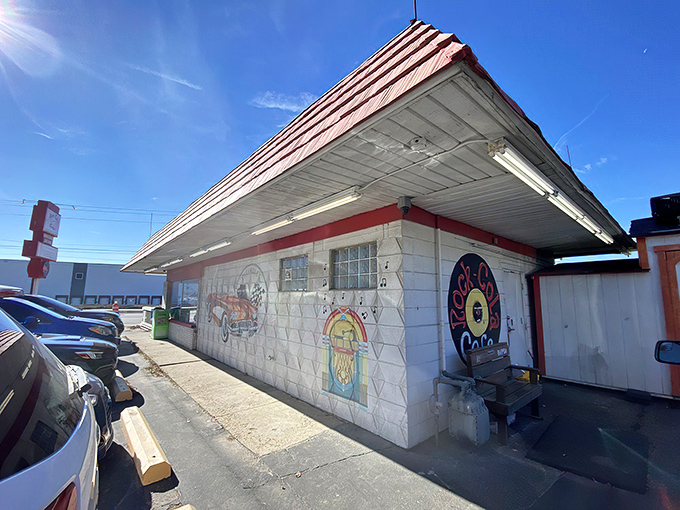 Welcome to time travel central! Rock-Cola's distinctive red roof and vintage car mural aren't just decoration&mdash;they're your first clue you've stumbled upon something special on Indy's east side.