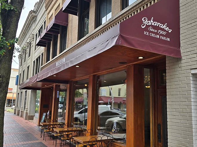 Step back in time with Zaharakos' stunning wooden façade – where the red awnings aren't just decorative, they're practically inviting you in for a sweet escape.