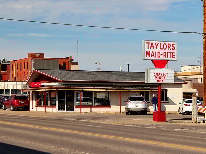 The classic red and white exterior of Taylor's Maid-Rite stands as a beacon of culinary tradition in downtown Marshalltown, promising loose-meat perfection within.