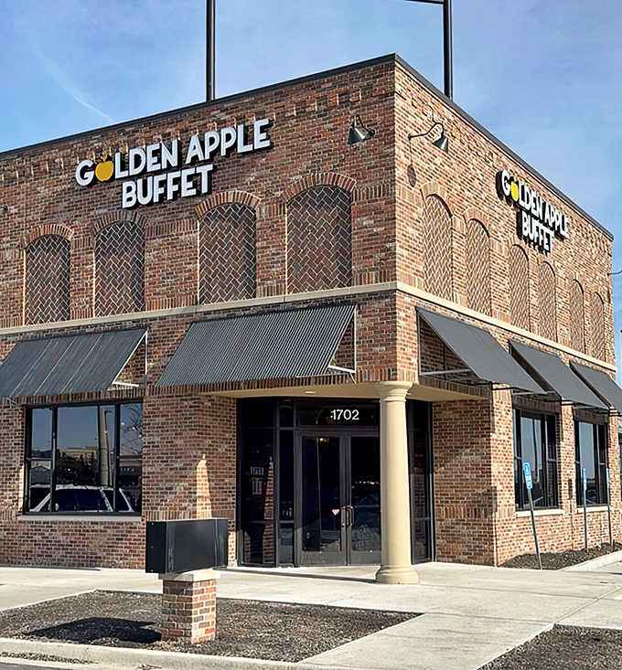 The brick facade of Golden Apple Buffet stands like a temple to abundance, promising culinary adventures behind those metal-awninged windows.