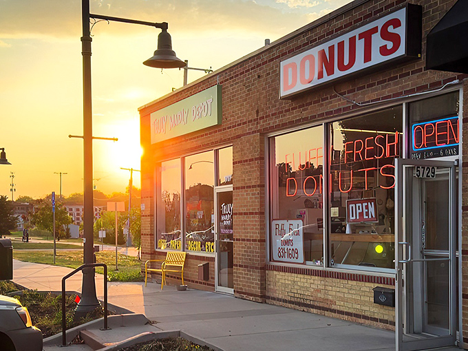 The brick facade and neon sign of Fluffy Fresh Donuts stands as a beacon of sweet promises on Johnson Drive. Mission accomplished!