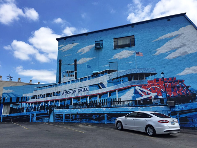 The blue-painted exterior of Anchor Grill features a stunning steamboat mural that's like a maritime welcome committee for hungry travelers.
