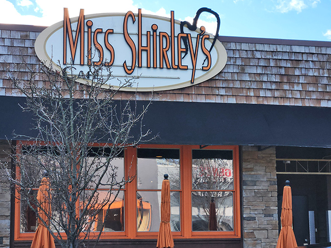 The iconic Miss Shirley's sign welcomes hungry pilgrims to breakfast paradise. Stone and wood exterior with signature orange lettering promises Southern comfort with Maryland flair.