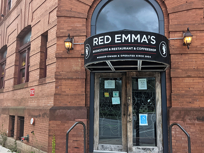 The iconic red brick exterior of Red Emma's stands as Baltimore's literary lighthouse, beckoning bibliophiles and coffee enthusiasts alike since 2004.