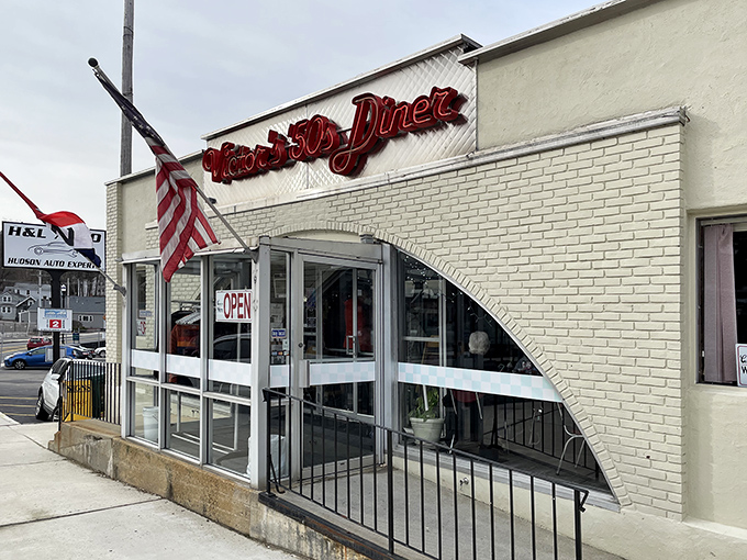 The classic white brick exterior of Victor's 50's Diner stands like a time capsule in Hudson, complete with that iconic red neon sign beckoning hungry travelers.