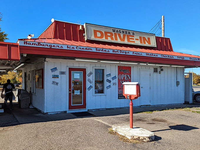The iconic red-roofed Wagner's Drive-In stands like a time portal to simpler days, beckoning hungry travelers with promises of hand-crafted burgers and nostalgia by the plateful.