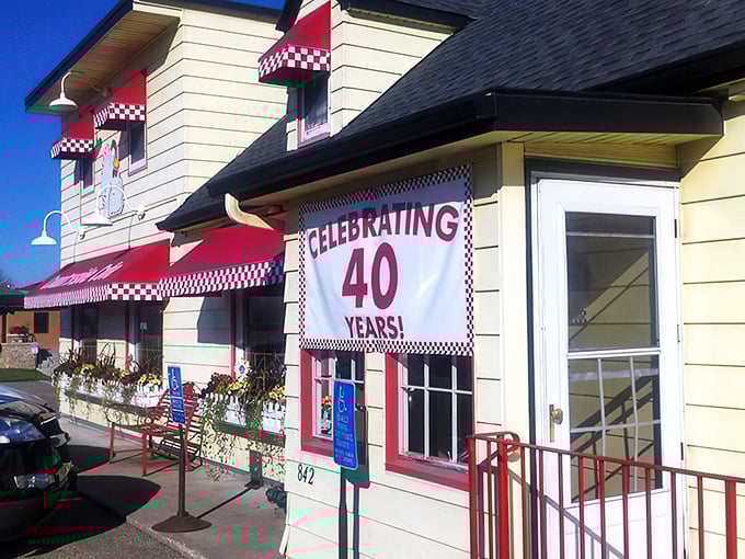 The iconic chicken mascot stands guard atop this cheerful yellow building, promising breakfast salvation to all who enter.
