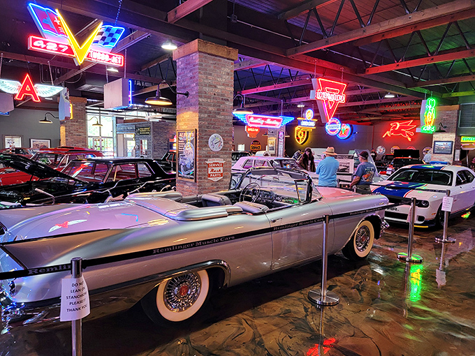 Step into automotive heaven where vintage storefronts and gleaming classics create a time-traveling wonderland. That blue convertible looks ready for a sunset cruise down memory lane.
