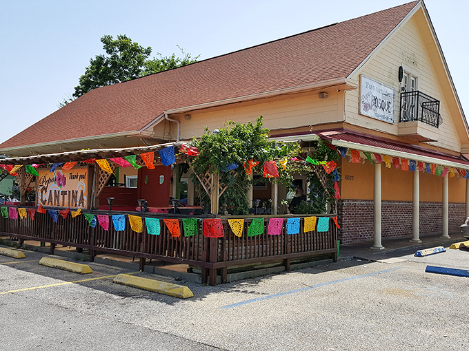 The cheerful yellow exterior of Pepe's Bosque beckons like an old friend, complete with a colorful patio that promises good times ahead. 