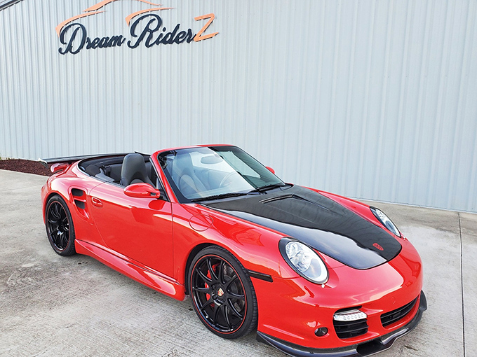 The classic American silhouette beneath the Dream Riderz sign&mdash;where nostalgia meets horsepower on the Mississippi horizon.