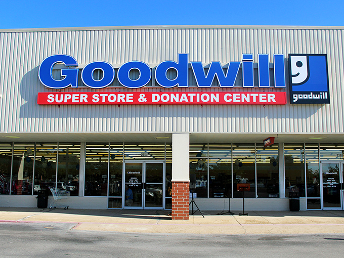 The curved facade of Goodwill's Super Store in Biloxi beckons like a blue-signed beacon of bargain possibilities, promising treasures waiting to be discovered inside.