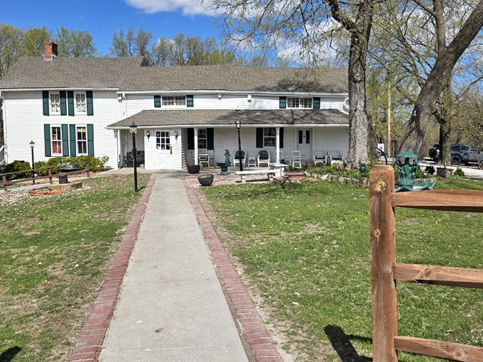 The white clapboard exterior of Stroud's Oak Ridge Manor stands like a time capsule of Americana, promising comfort food treasures within its unassuming walls.