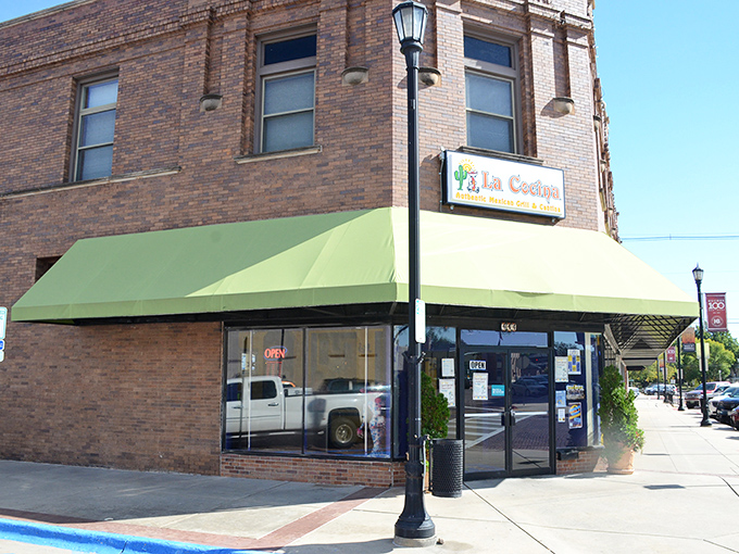 La Cocina's unassuming brick exterior with its cheerful green awning stands as Seward's culinary beacon, promising Mexican treasures within.
