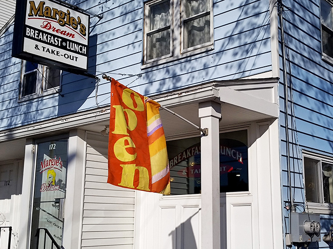 The iconic blue exterior of Margie's Dream Diner stands like a beacon of breakfast hope against the New Hampshire sky. Small building, big flavors.