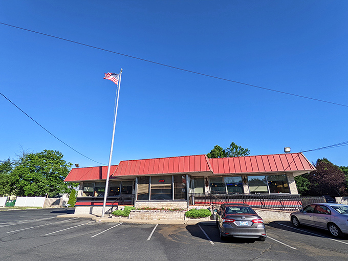The iconic red roof of Route 1 Diner stands as a beacon to hungry travelers, promising comfort food and Jersey hospitality just off the highway.