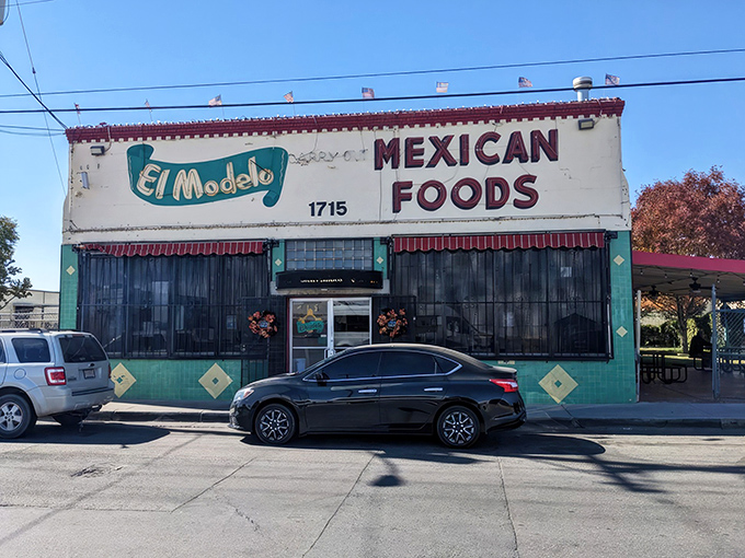 The unassuming turquoise and white facade of El Modelo stands like a culinary lighthouse in Albuquerque's Barelas neighborhood, beckoning hungry souls for generations.