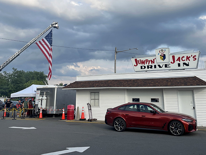 The iconic Jumpin' Jack's sign stands proudly against dramatic skies, while Old Glory waves from a fire truck ladder&mdash;a Scotia summer tradition in full swing.